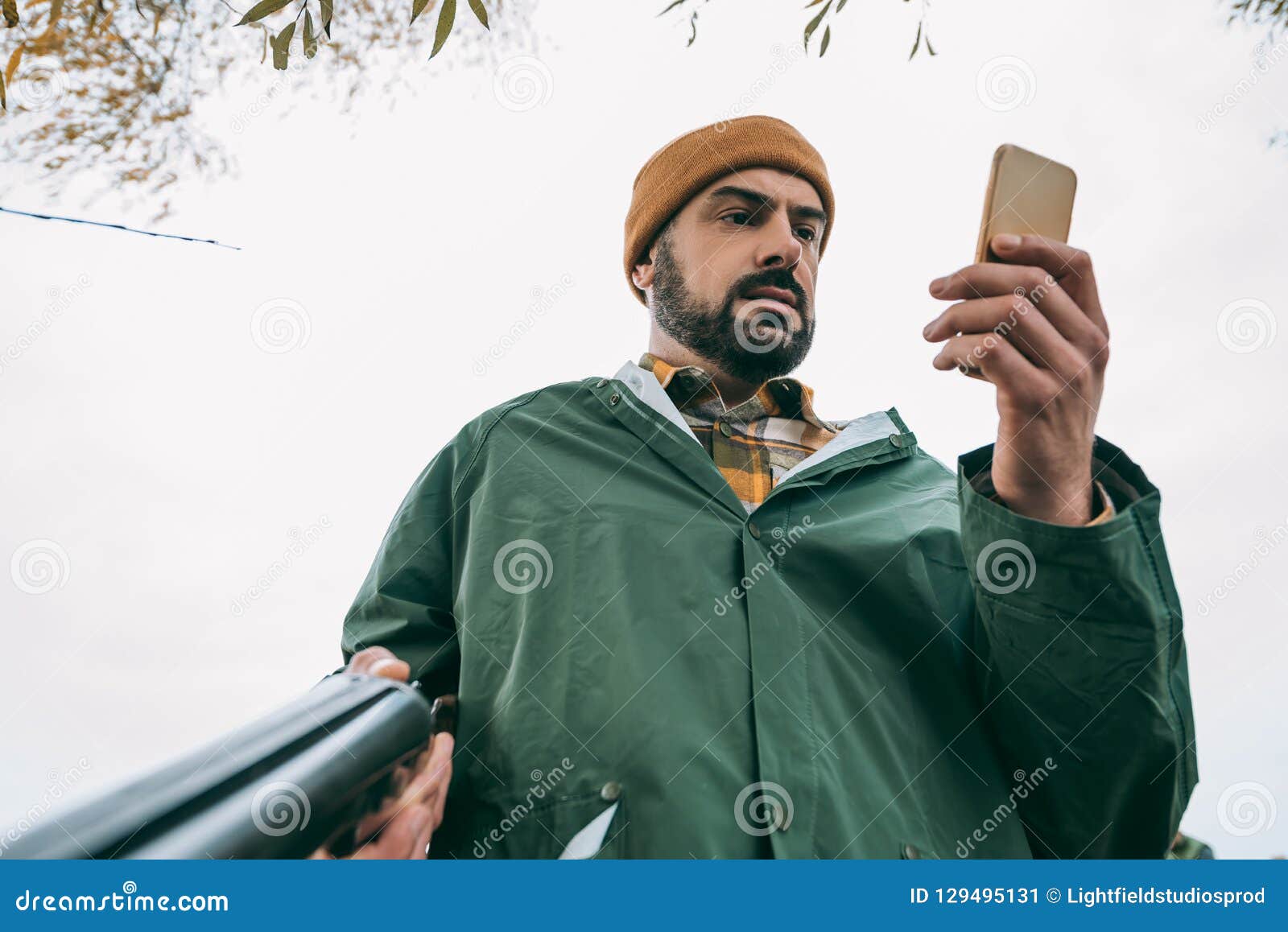 Bottom View of Handsome Hunter Standing with a Gun and Looking Stock ...