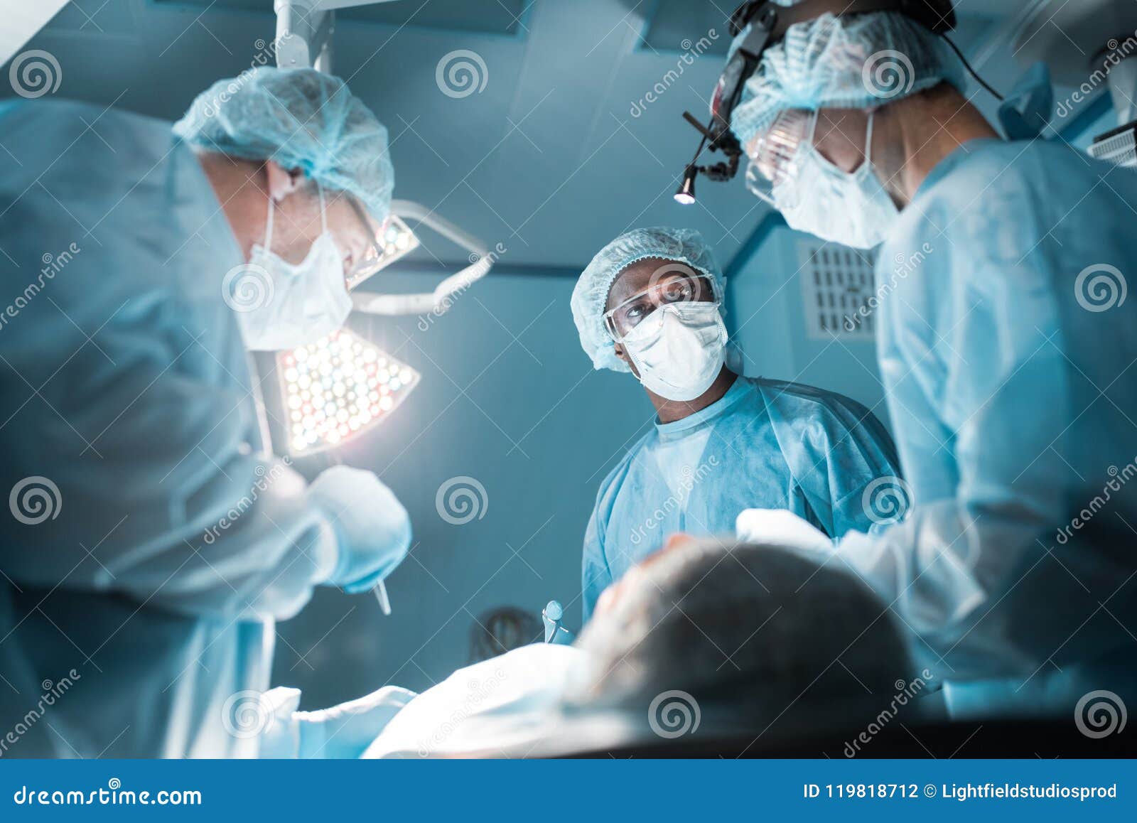 Bottom View of Multicultural Surgeons Operating Patient Stock Photo ...