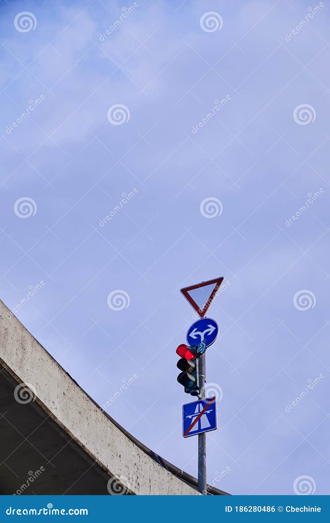 Bottom View of a Red Traffic Light and Various Traffic Signs at an ...