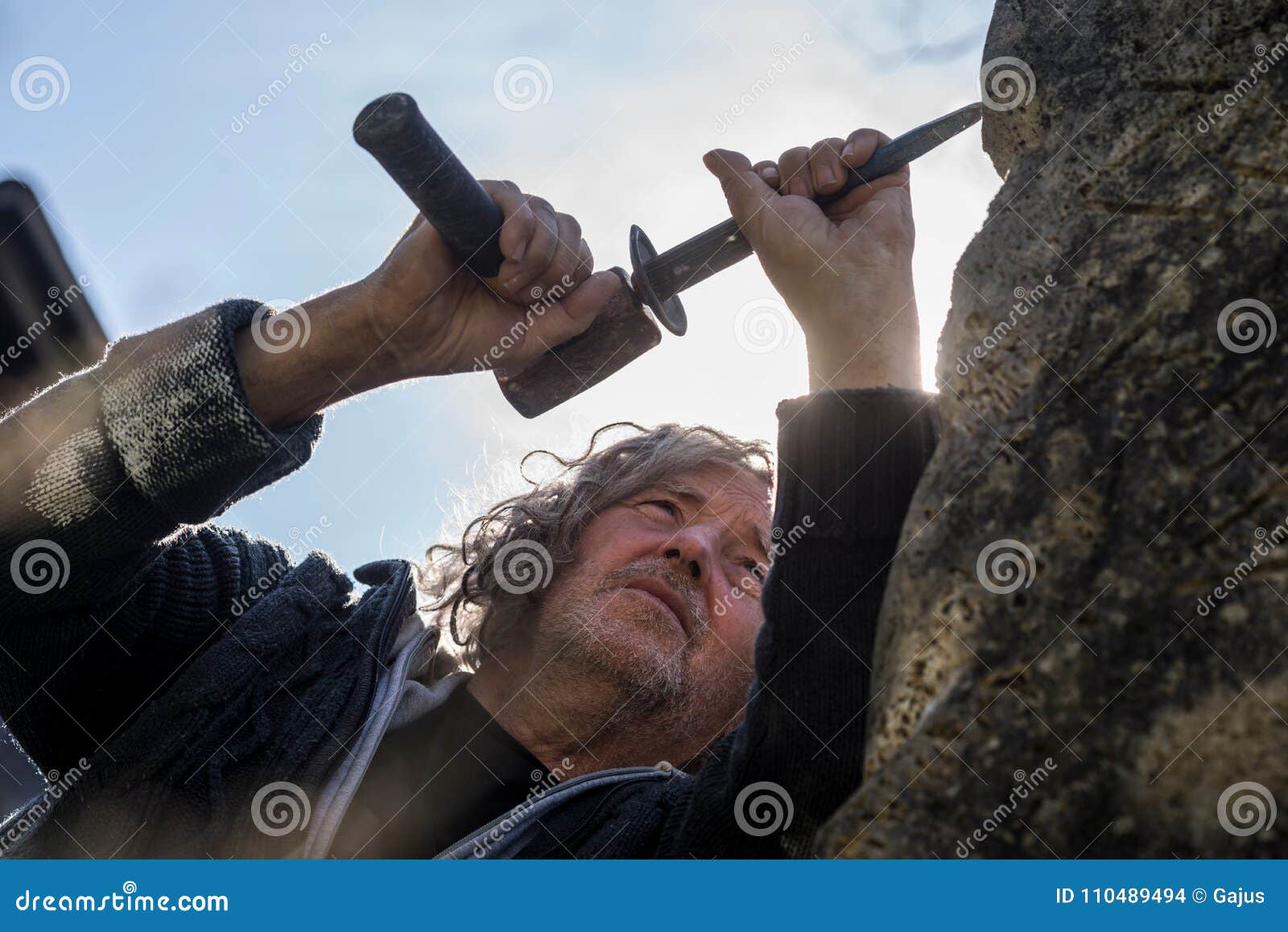 Bottom View of Sculptor Sculpting with Chisel and Hammer Stock Photo ...