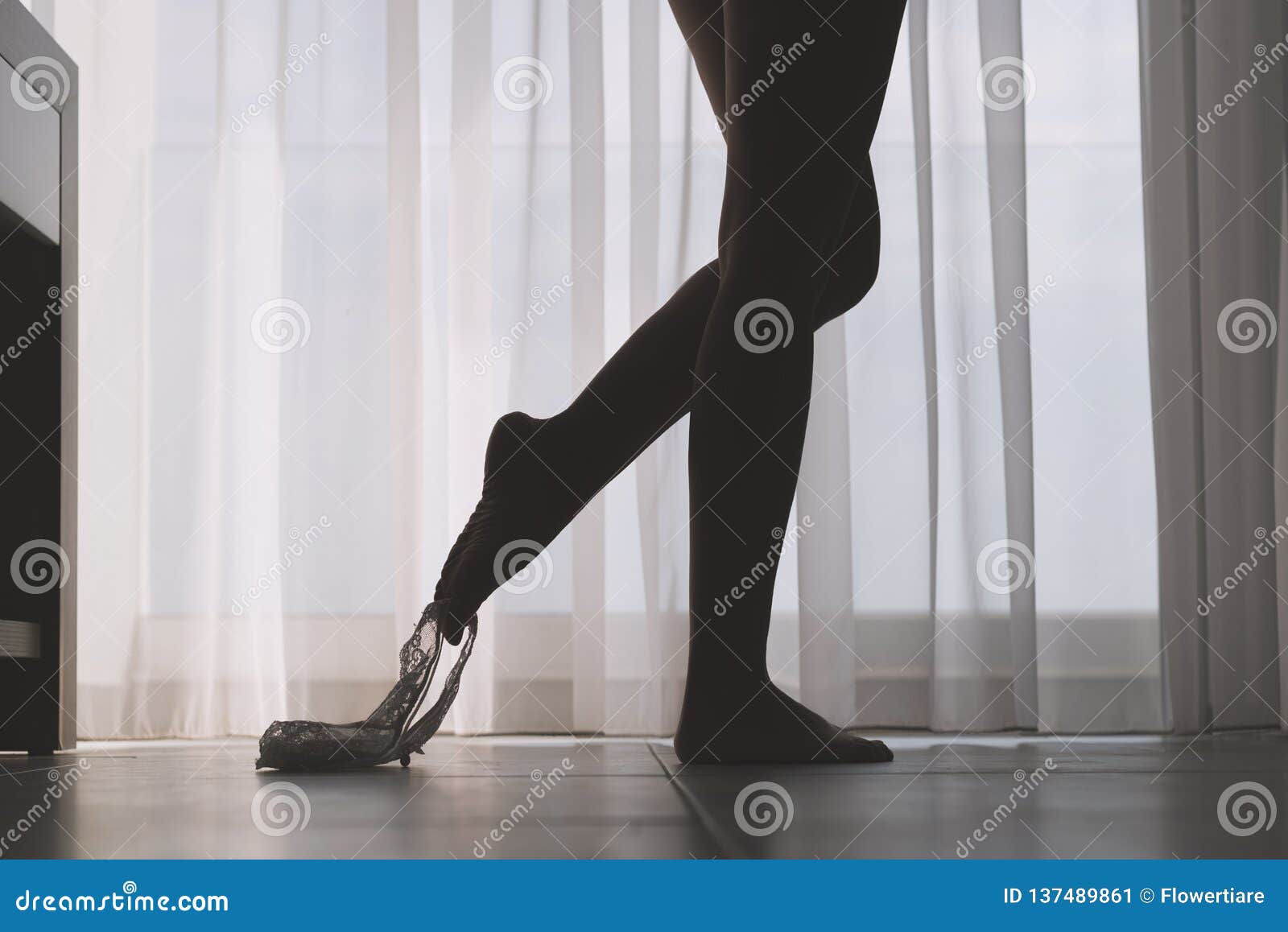 Bottom View Of Silhouette Of Beautiful Female With Legs Taking Off Her