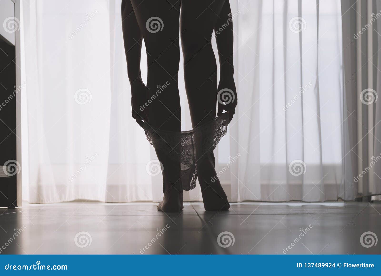 Bottom View Of Silhouette Of Beautiful Female With Legs Taking Off Her