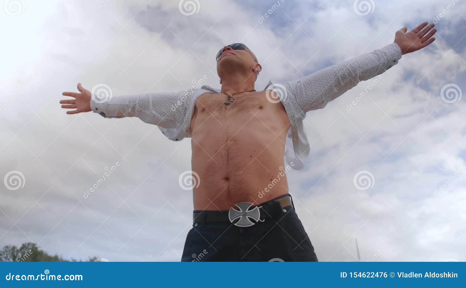 Bottom View of a Standing Man and Spreading His Arms Against the ...