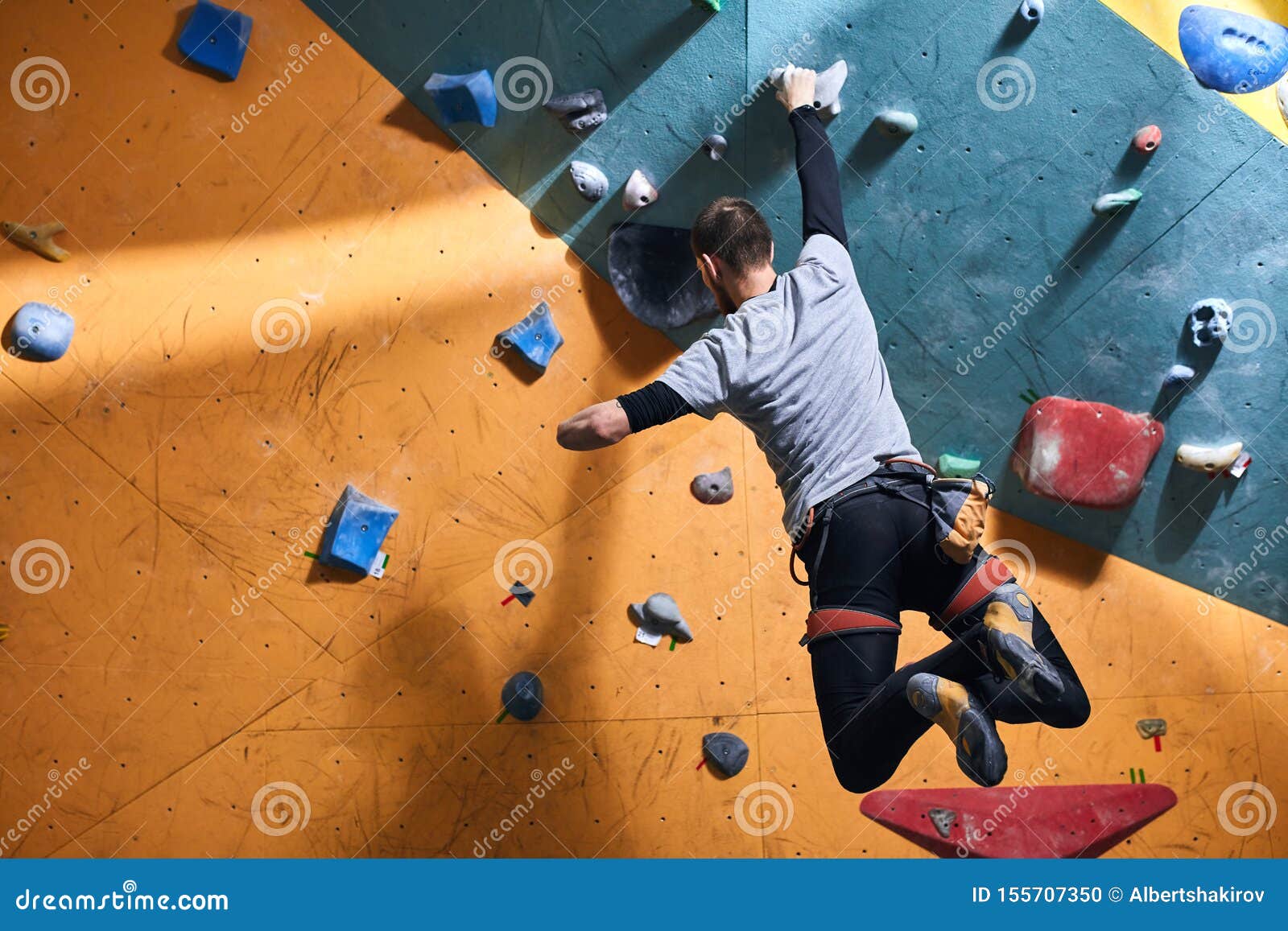 Boulderer with Physical Disability Hanging at Rock Wall, Balancing on ...