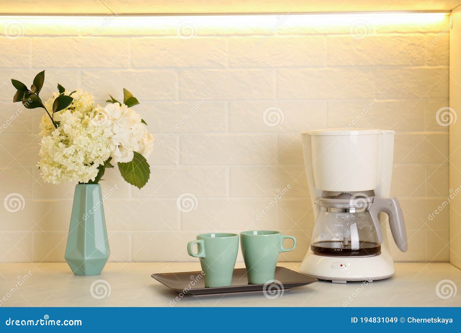 Bouquet with White Hydrangea Flowers, Coffee Maker and Cups on Light ...