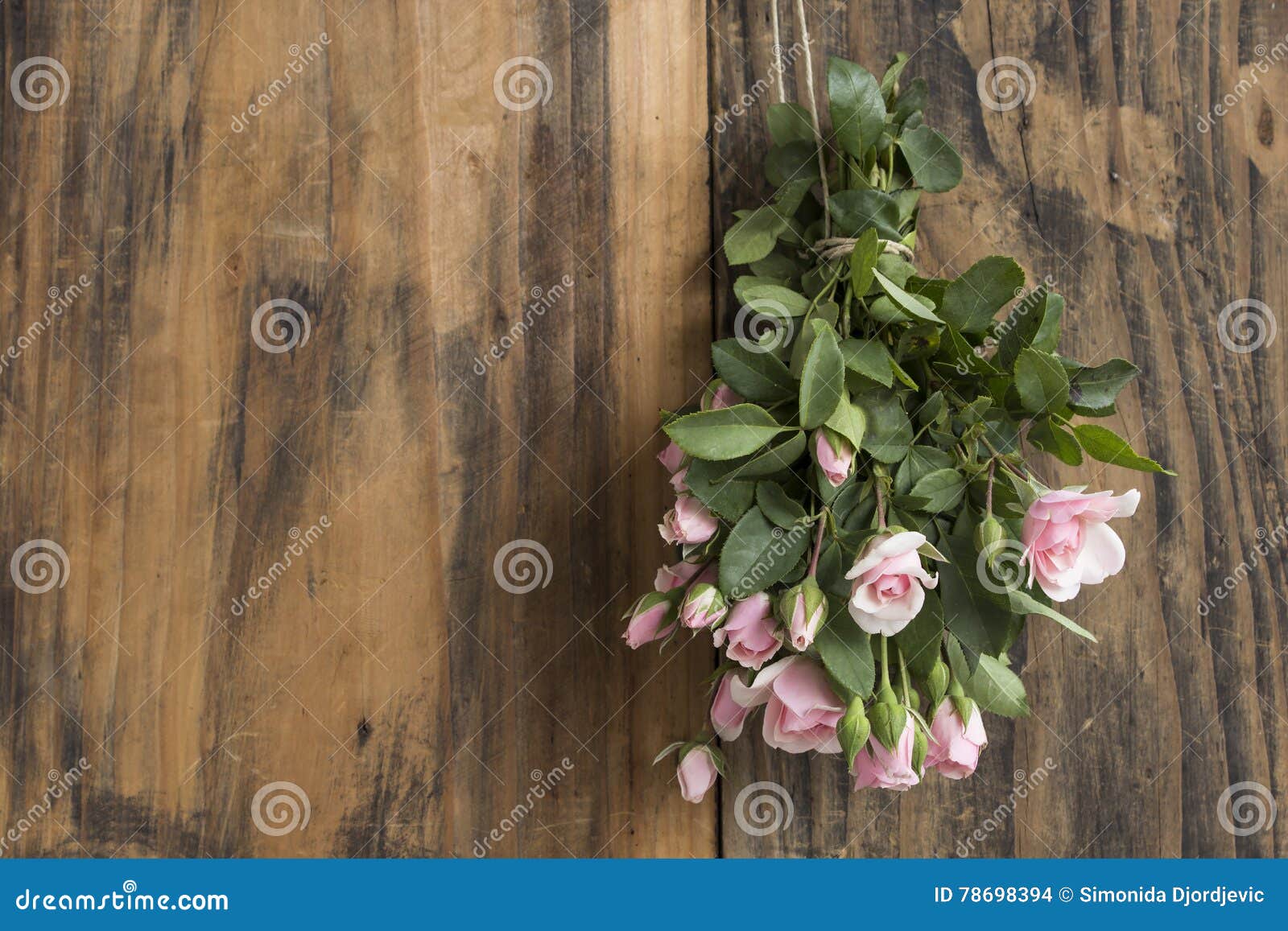 Bouquet of Pink Roses on a Rustic Background of a Board Stock Photo ...