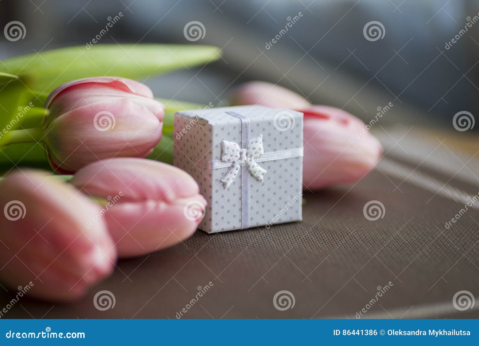 Bouquet of Pink Tulips with Gift Box on Table Stock Photo - Image of ...