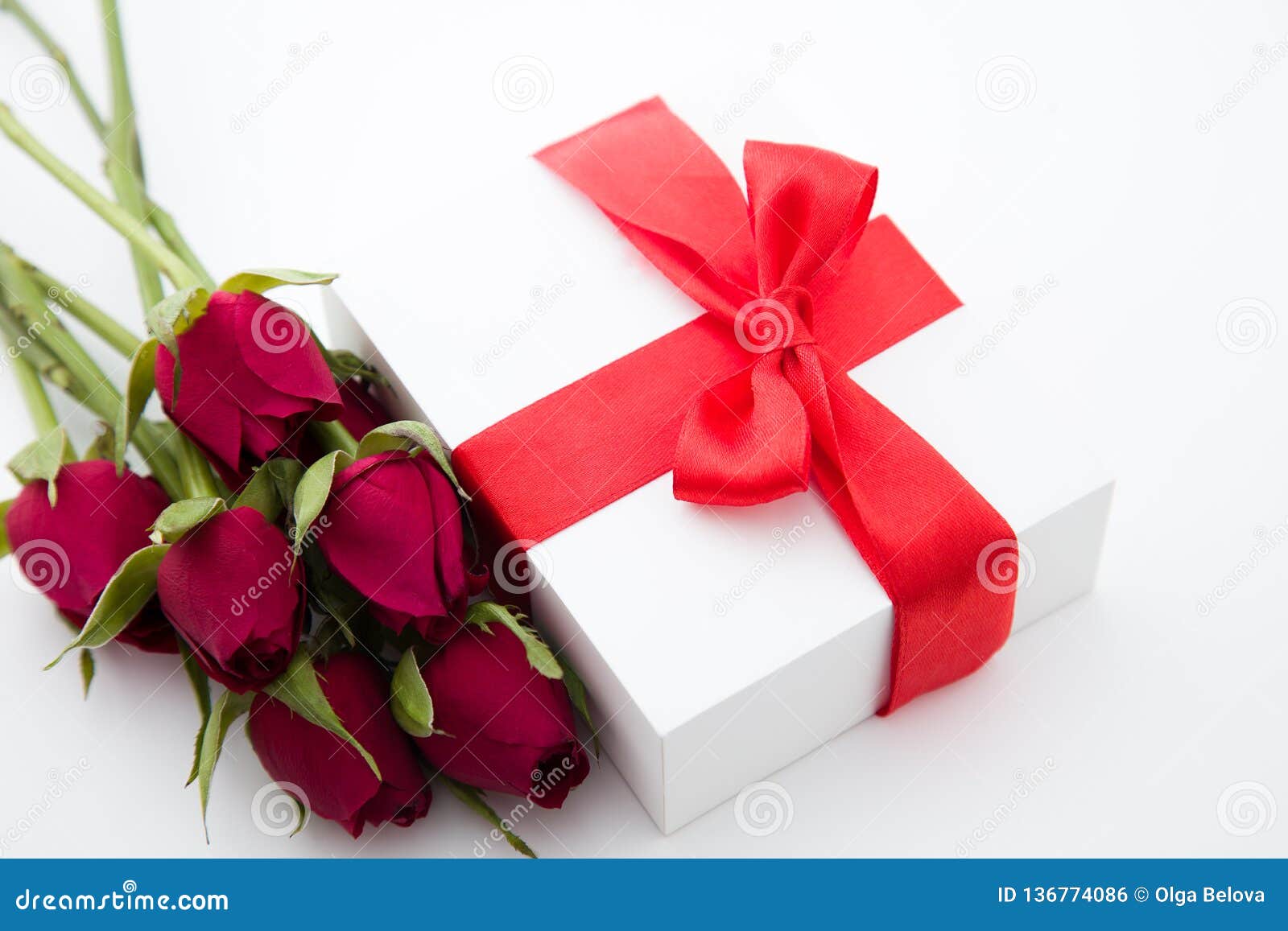 Bouquet of Red Roses with a Gift Stock Photo - Image of gift, ribbon ...