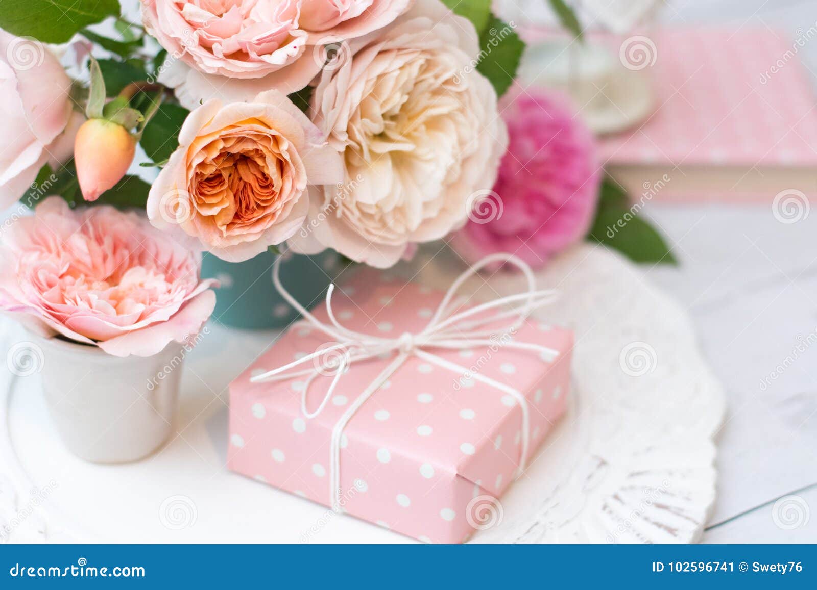 Bouquet of roses and gift stock image. Image of flower - 102596741