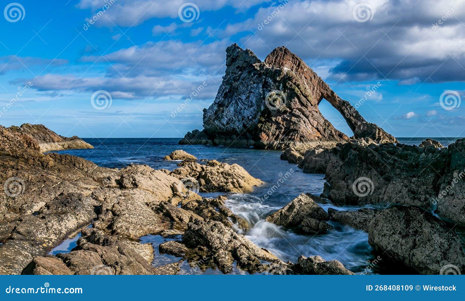 Bow Fiddle Rock with a Cloudy Blue Sky in the Background in Scotland ...