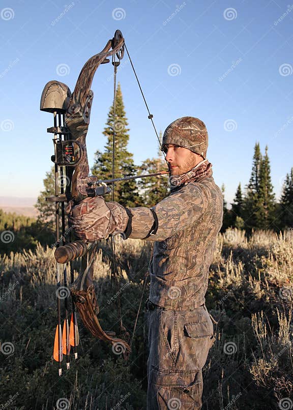 Bow Hunter Drawing Compound Bow in Mountains Stock Image - Image of ...