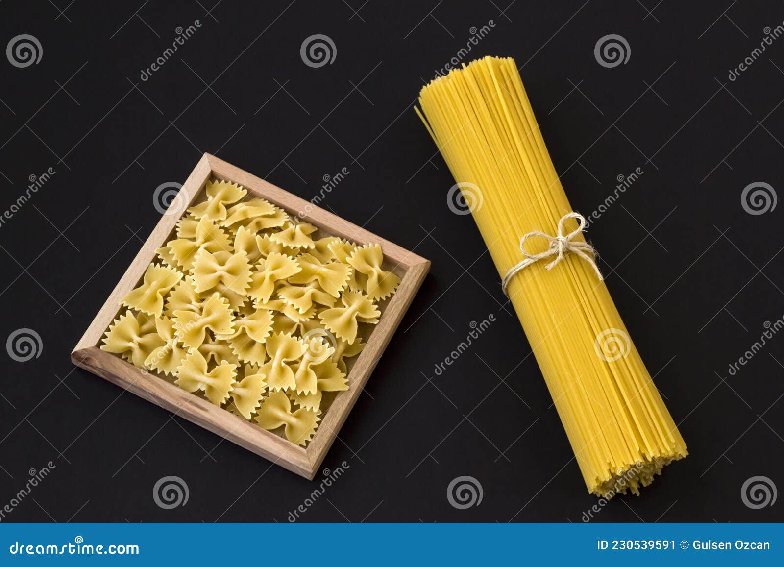 Bow Shaped Pasta Wooden Box with Spaghetti on Black Surface Stock Image ...