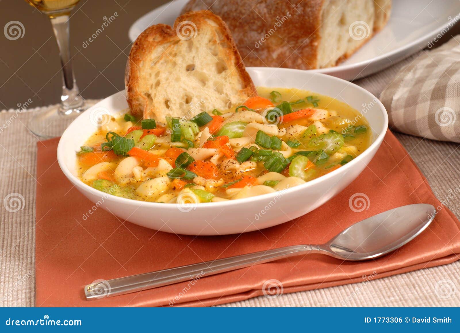 Bowl of Chicken Noodle Soup with Rustic Bread and a Glass of Win Stock ...