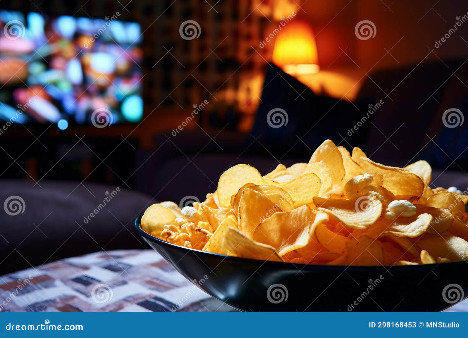 Bowl of Chips in Front of TV Screen. Watching Television at Home Stock ...