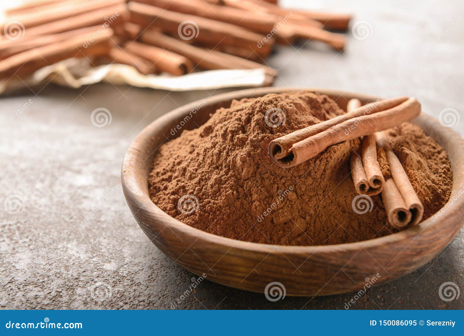 Bowl with Cinnamon Powder on Table, Closeup Stock Image - Image of ...