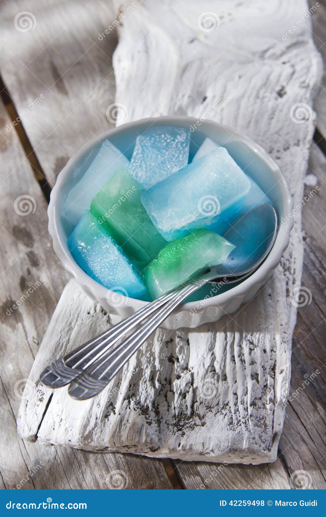Bowl of colored ice-cubes stock photo. Image of small - 42259498