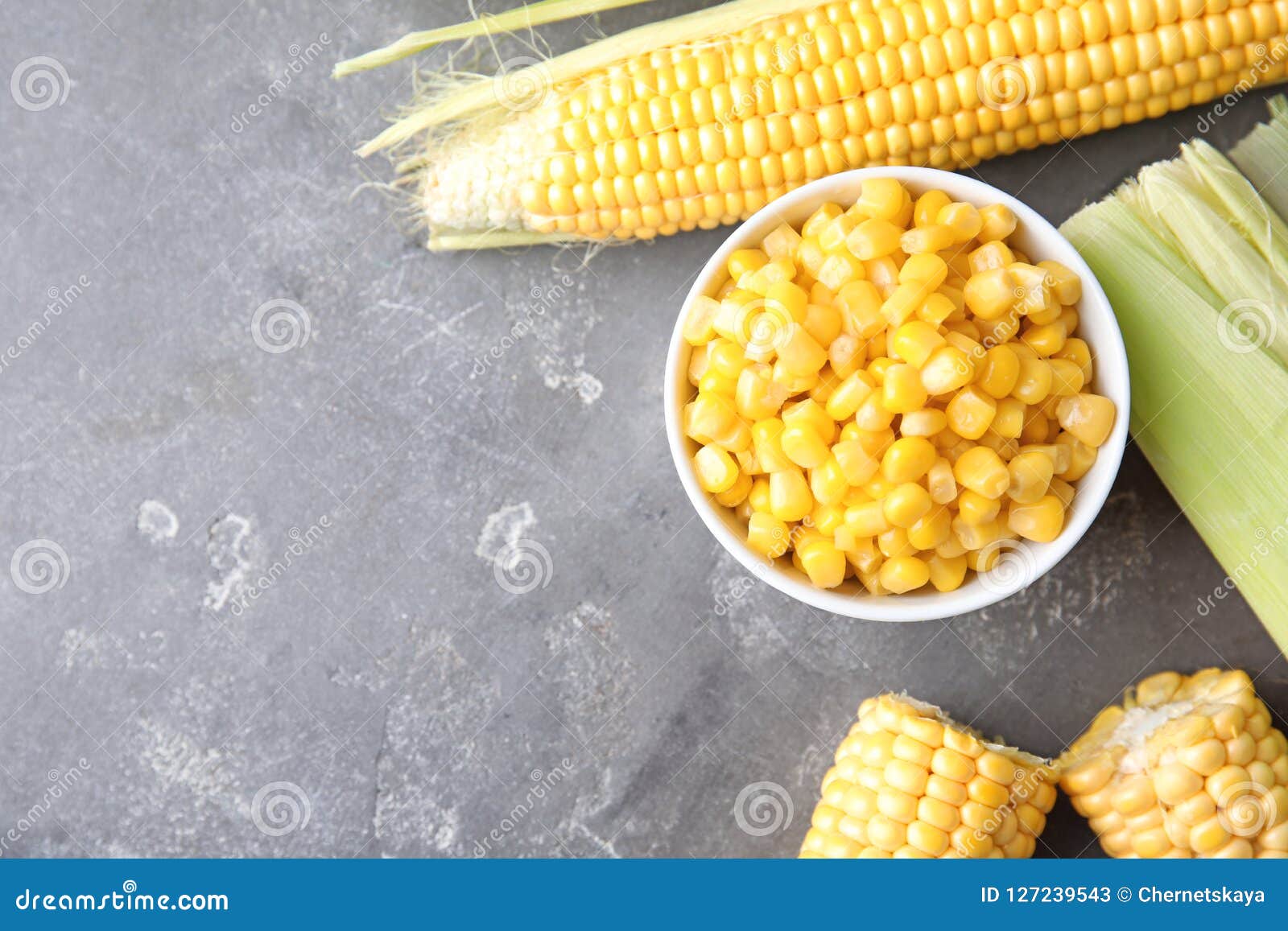 Bowl with Corn Kernels and Ripe Cobs on Grey Background, Top View Stock ...