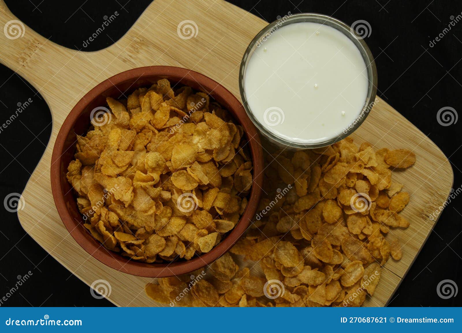 A Bowl of Cornflakes and a Glass of Milk on the Kitchen Board High ...