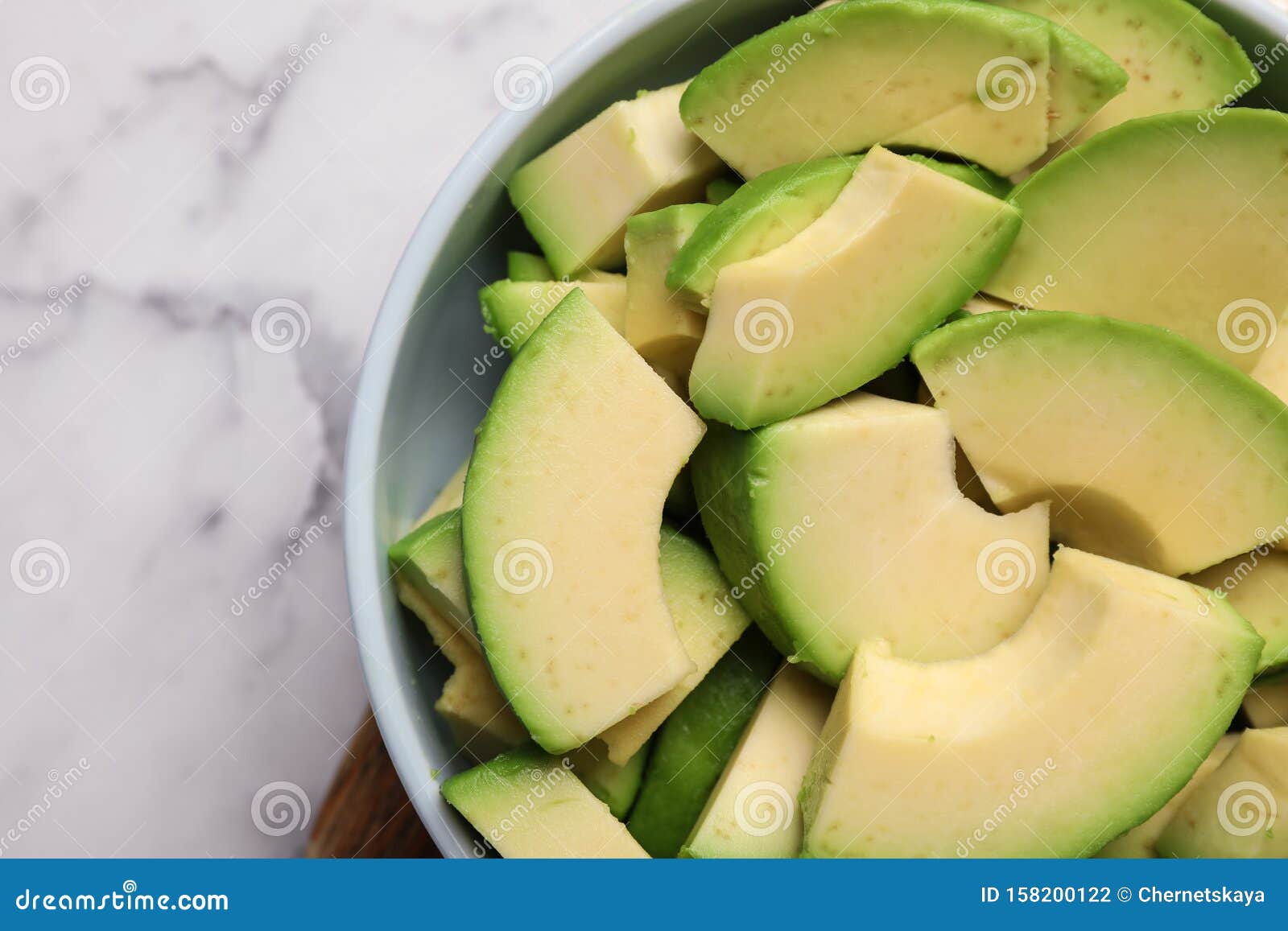 Bowl with Cut Avocados on Marble Table Stock Photo - Image of green ...