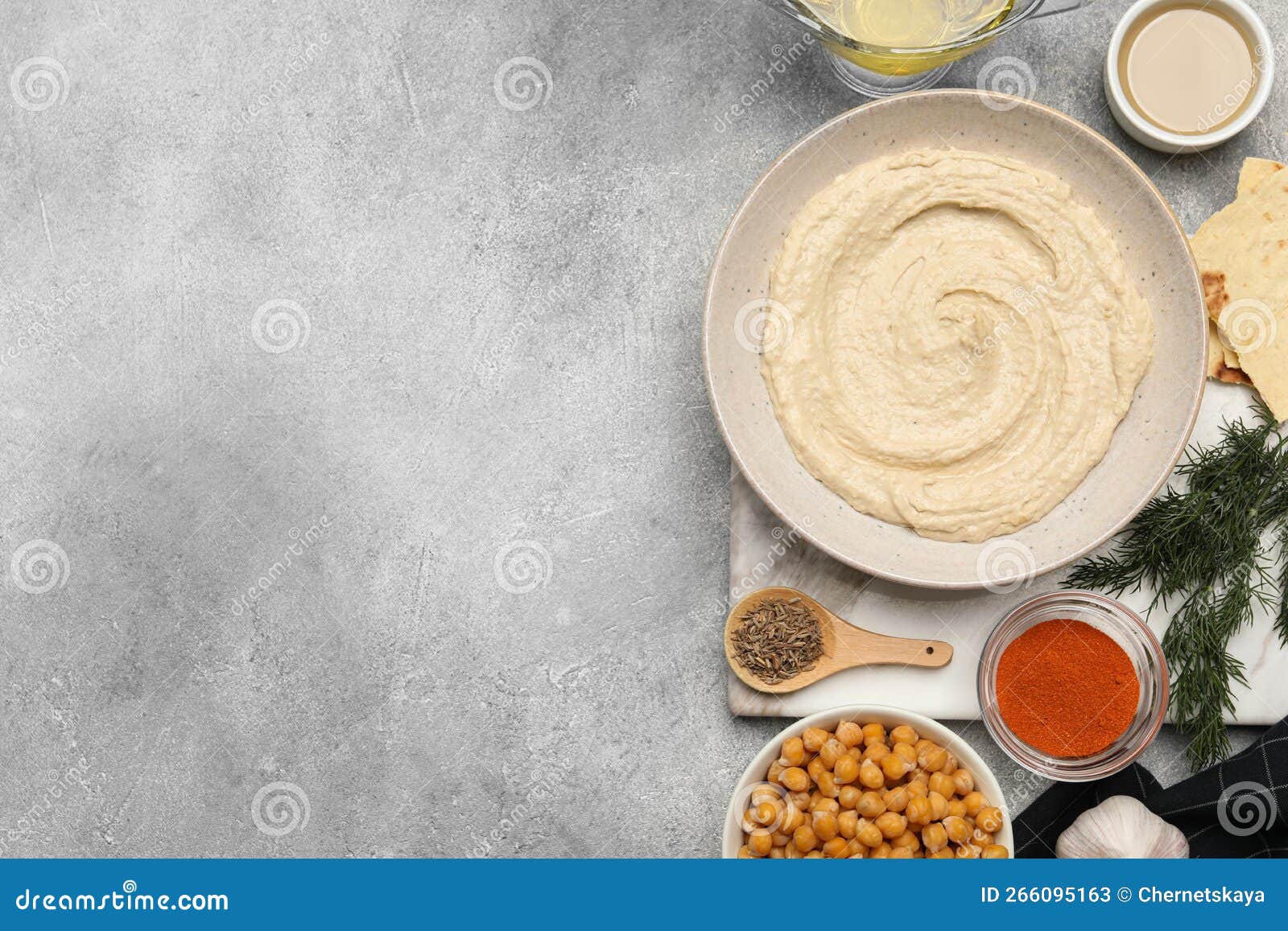 Bowl with Delicious Hummus and Different Ingredients on Light Grey ...