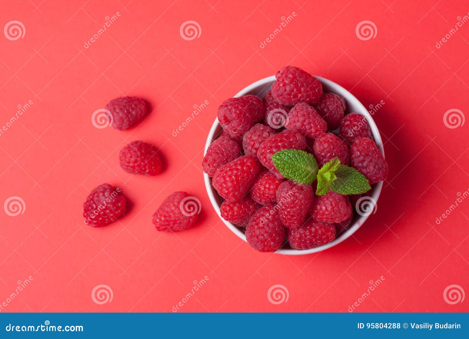 Bowl with Fresh Raspberries and Mint Leaves on a Red Background. Top ...