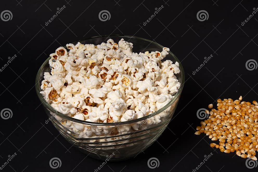 A Bowl of Fried Popcorn and Corn Kernels on a Black Background Stock ...