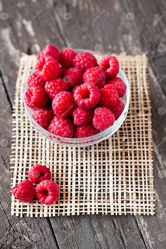 Bowl Full of Raspberry on the Table Stock Photo - Image of meal, leaf ...