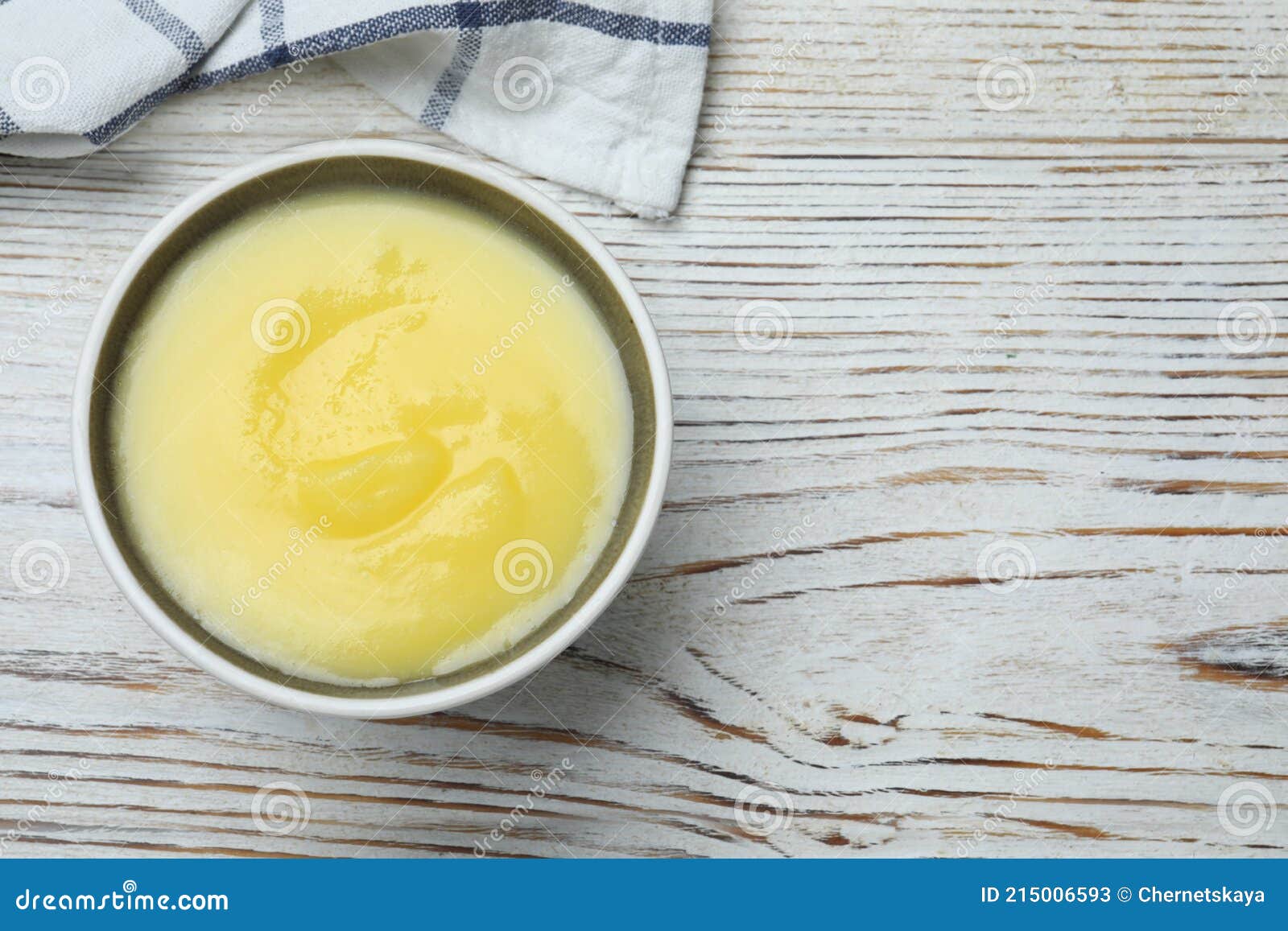 Bowl of Ghee Butter on White Wooden Table, Top View. Space for Text ...