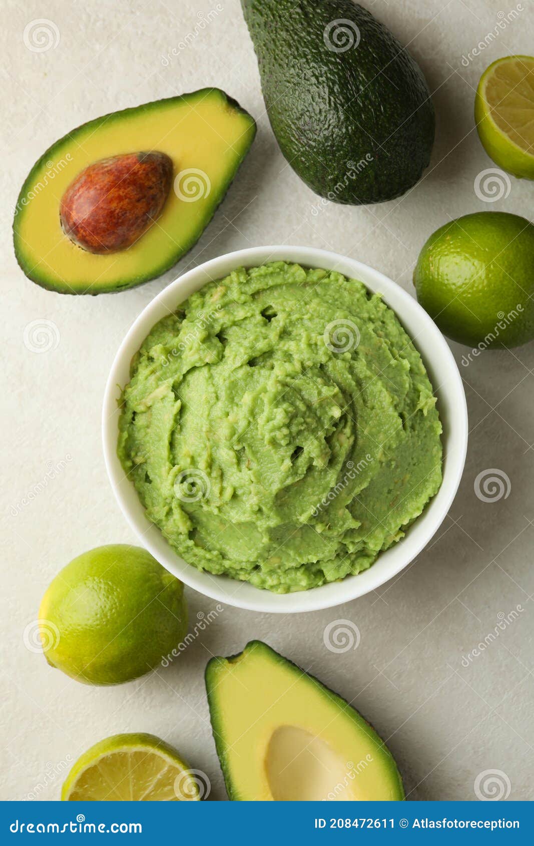 Bowl of Guacamole, Avocado and Lime on White Textured Background, Top ...