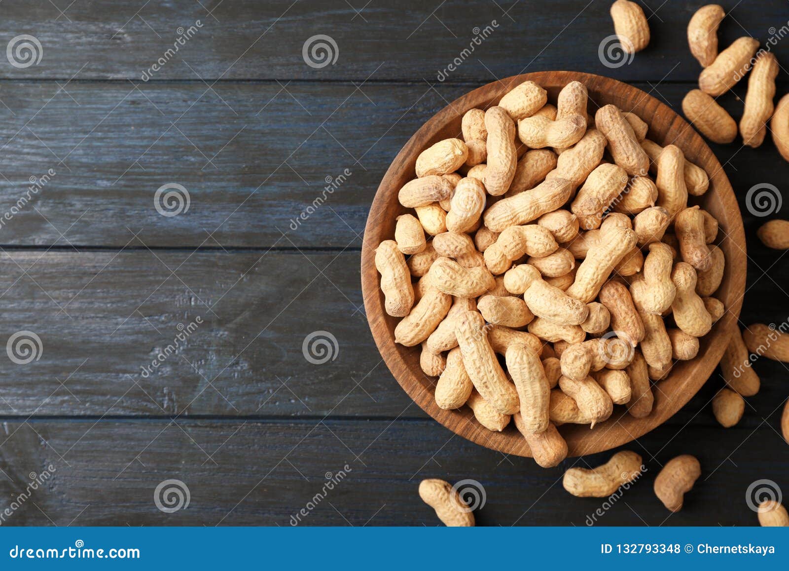 Bowl with Peanuts in Shell and Space for Text on Wooden Table Stock ...
