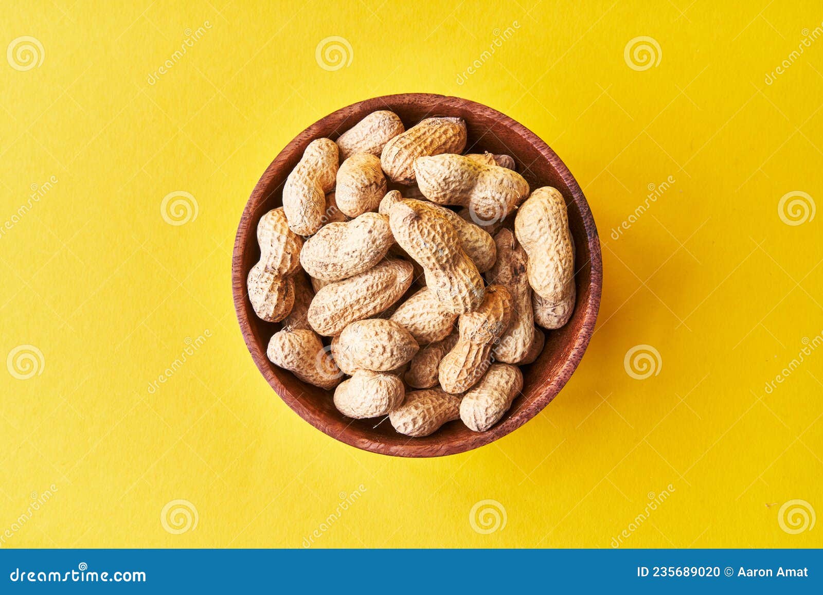 Bowl of Peanuts with Shell on a Yellow Background Stock Photo - Image ...