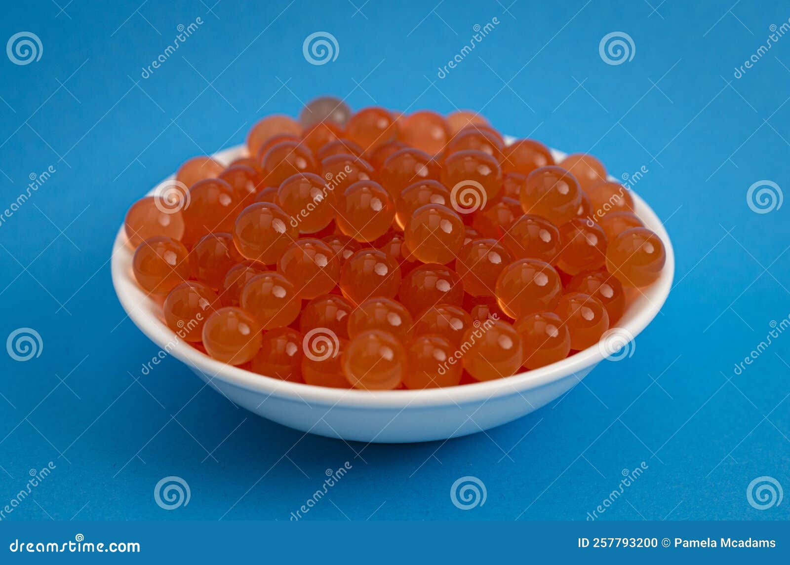 Bowl of Popping Boba Pearls on a Bright Blue Background Stock Photo ...