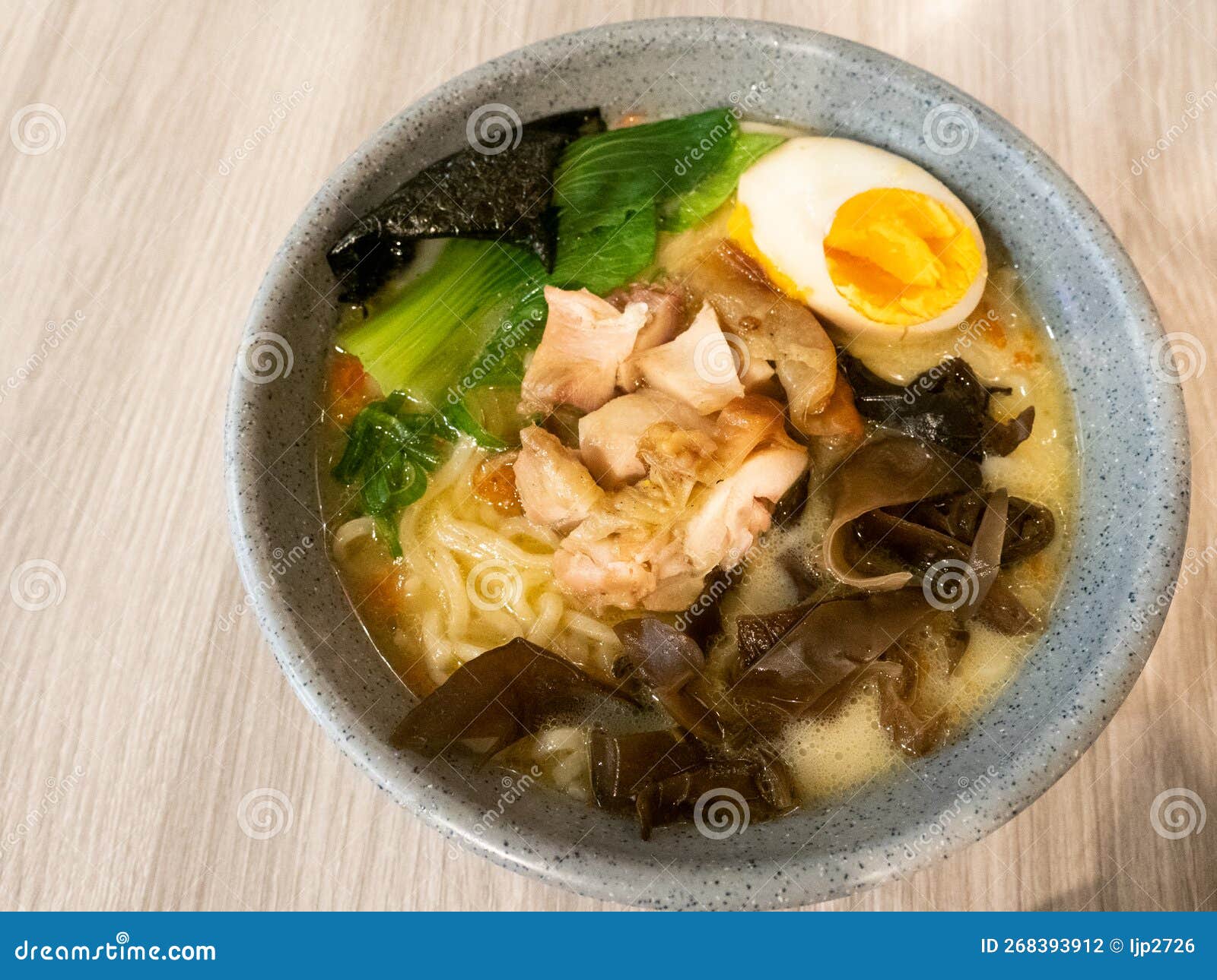 A Bowl of Ramen on a Wooden Table Stock Photo - Image of miso, leaf ...