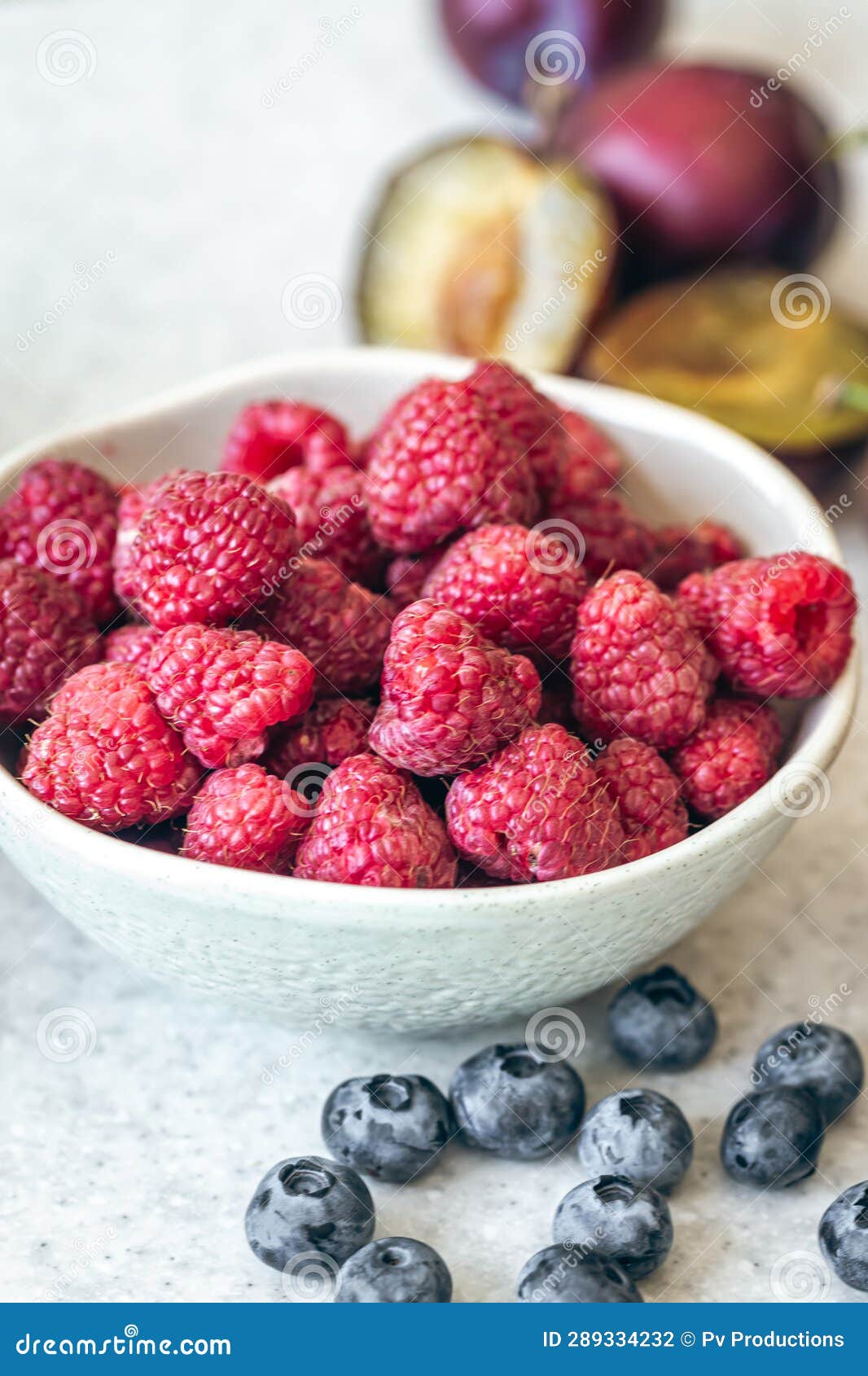 Bowl with Raspberries on the Kitchen Table, Close-up. Stock Photo ...