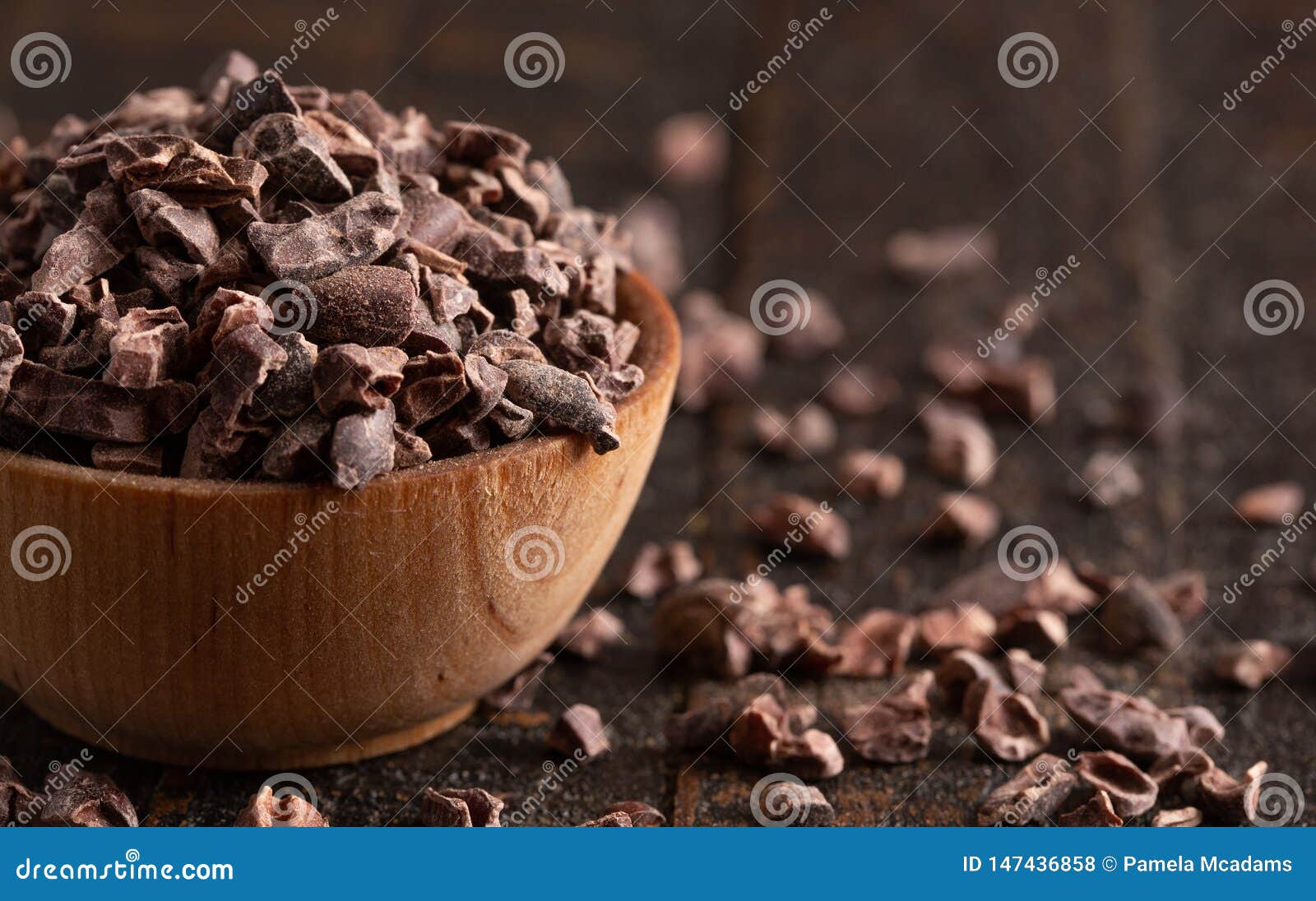 Bowl of Raw Chocolate Nibs on a Rustic Wooden Table Stock Photo - Image ...