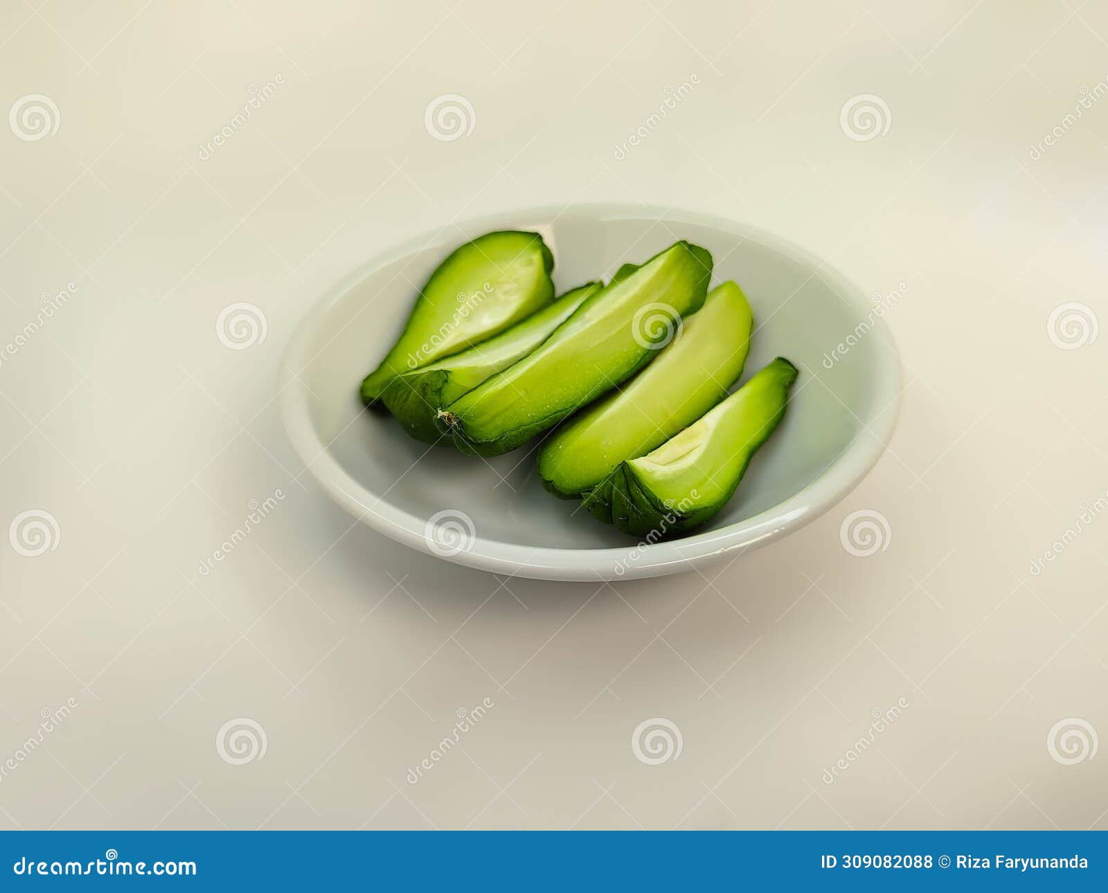 A Bowl of Several Pieces of Boiled Chayote on a White Background Stock ...