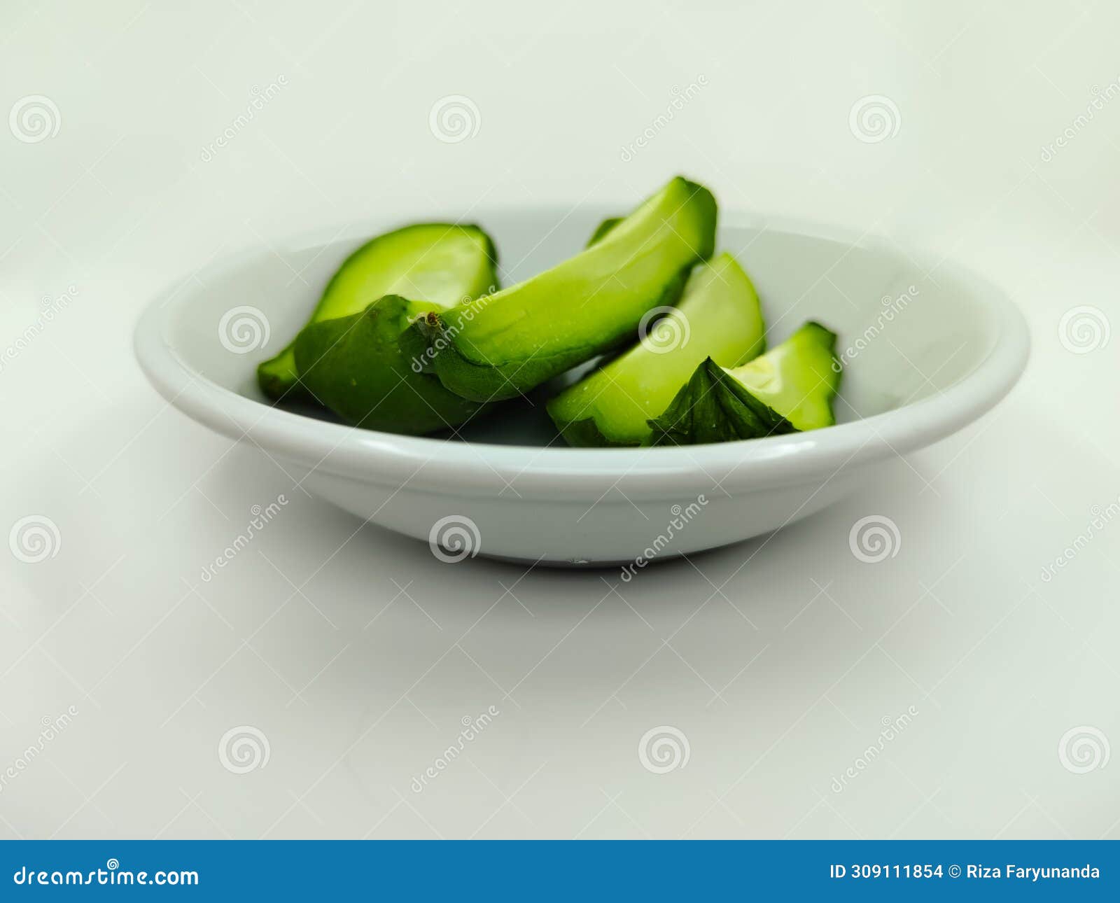 A Bowl of Several Pieces of Boiled Chayote on a White Background Stock ...