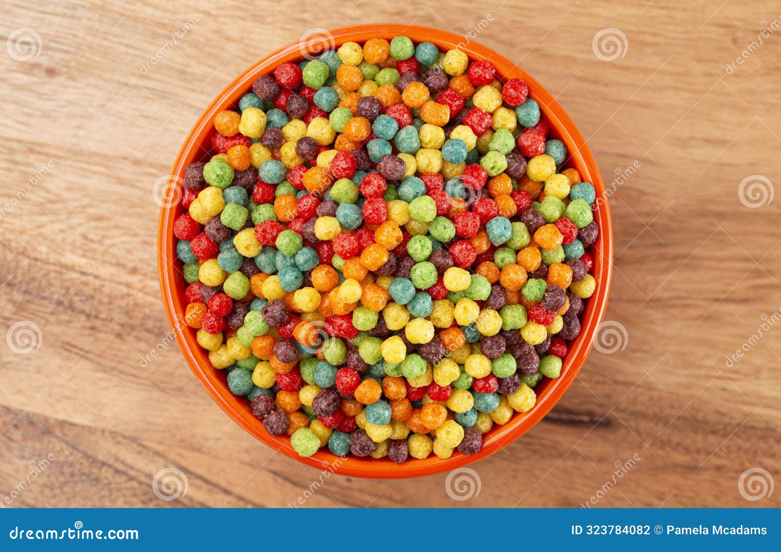 A Bowl of Small Ball Shaped Fruit Flavored Breakfast Cereal on a Wooden ...