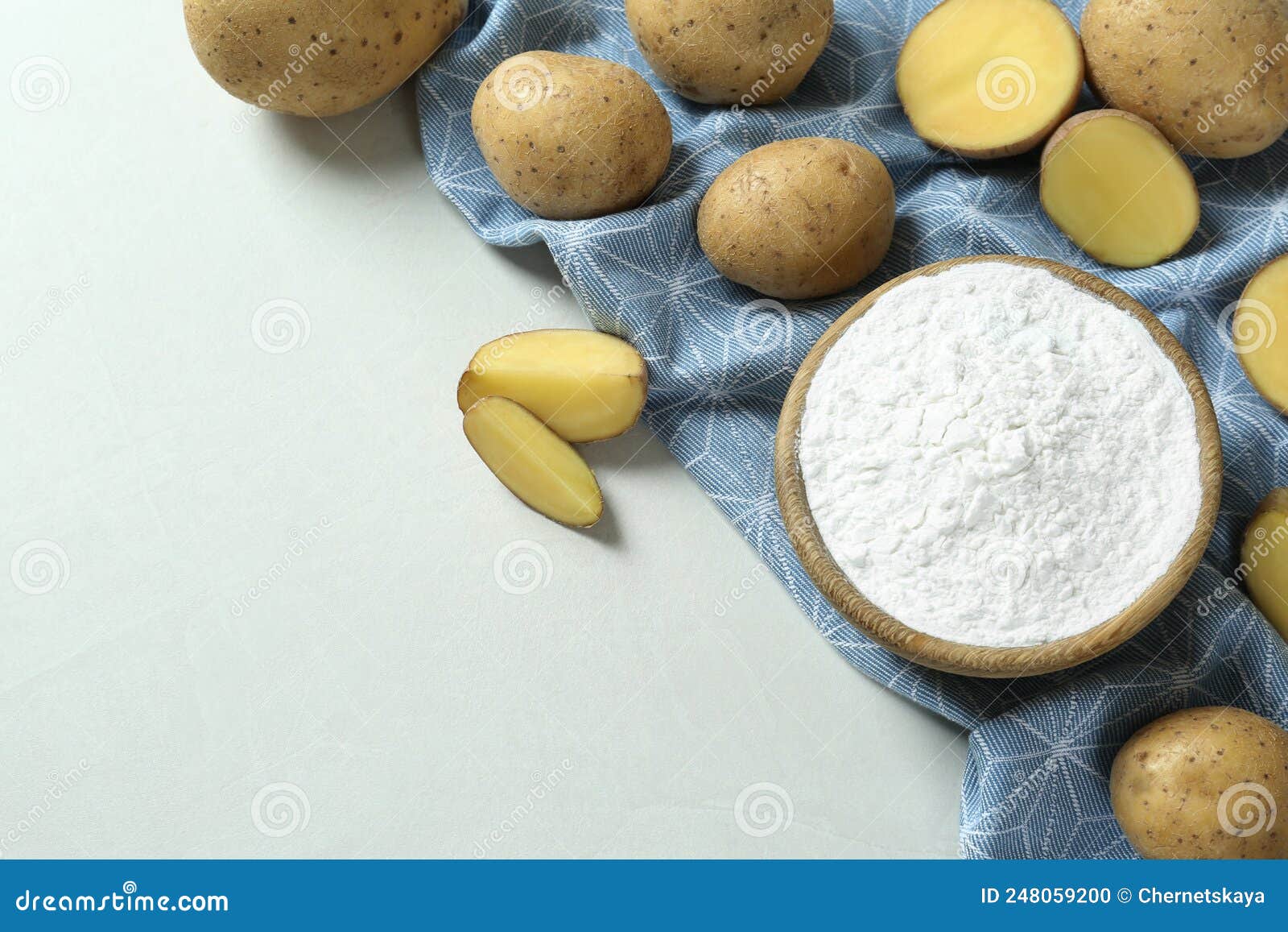 Bowl with Starch and Fresh Potatoes on White Table, Flat Lay. Space for ...