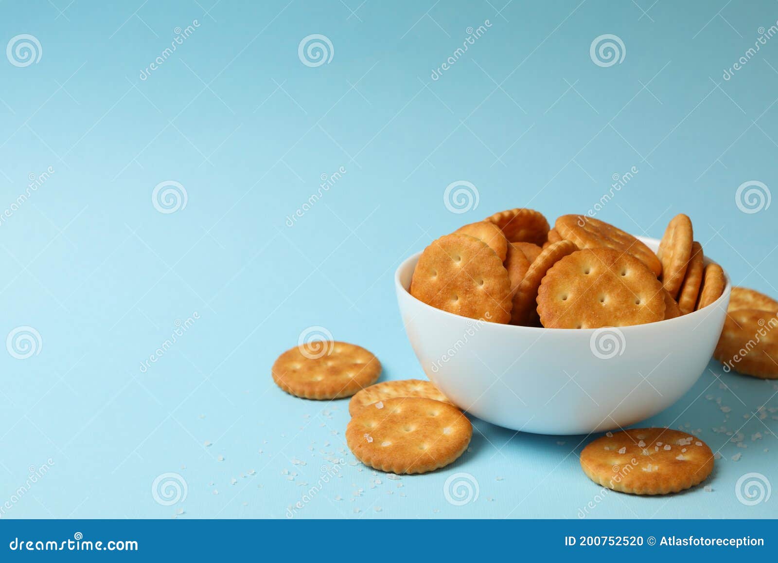 Bowl with Tasty Cracker Biscuits on Blue Background Stock Photo - Image ...