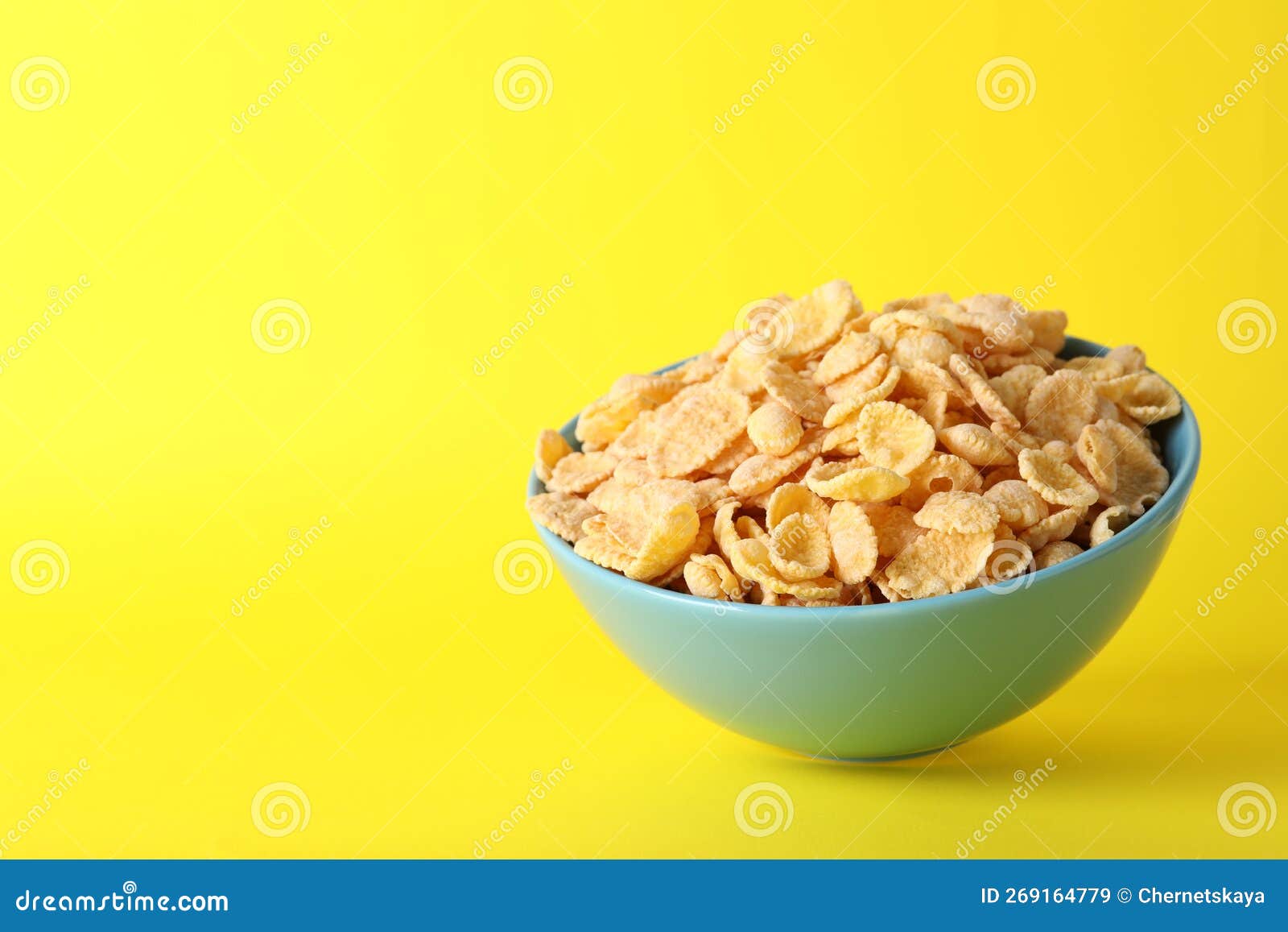 Bowl of Tasty Crispy Corn Flakes on Yellow Background, Space for Text ...