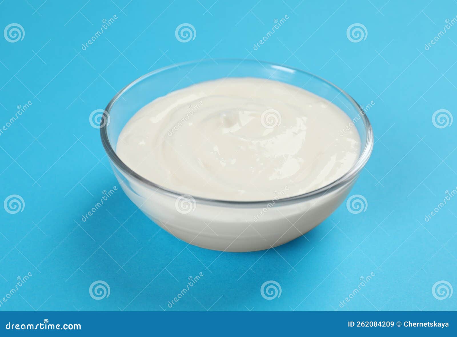 Bowl of Tasty Organic Yogurt on Light Blue Background Stock Image ...