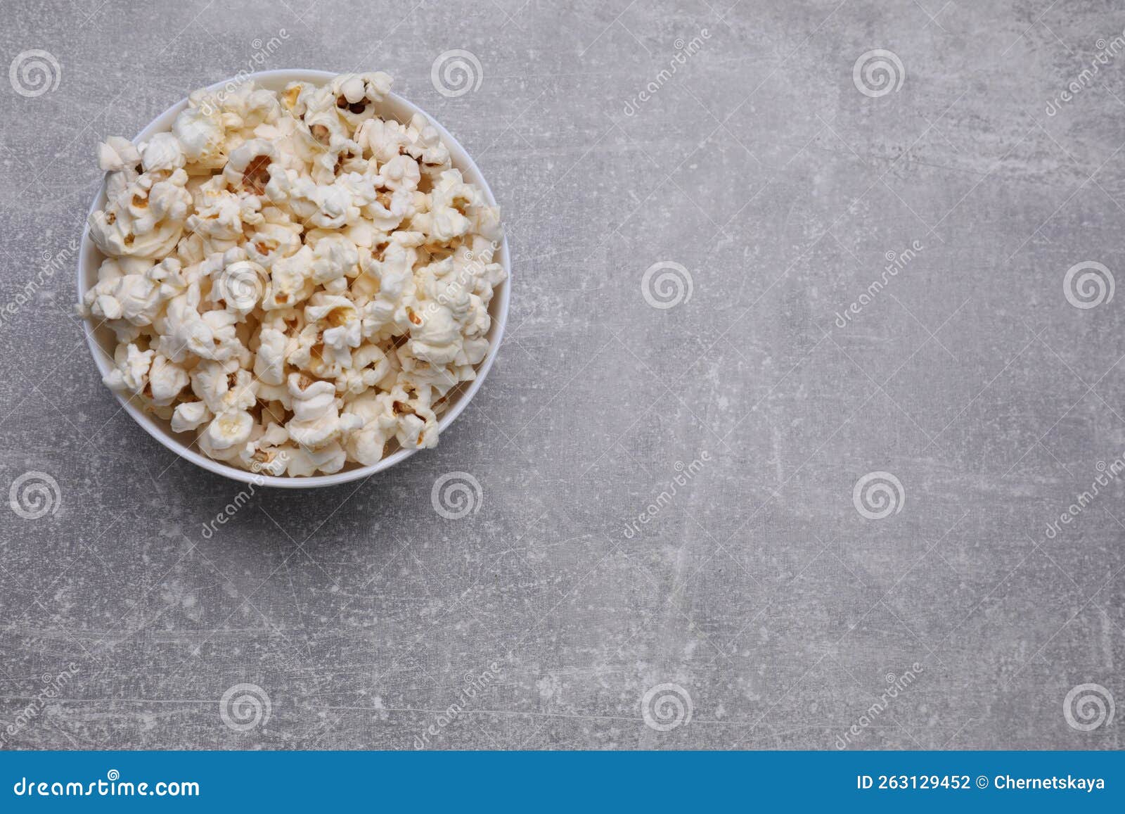 Bowl of Tasty Popcorn on Grey Table, Top View. Space for Text Stock ...