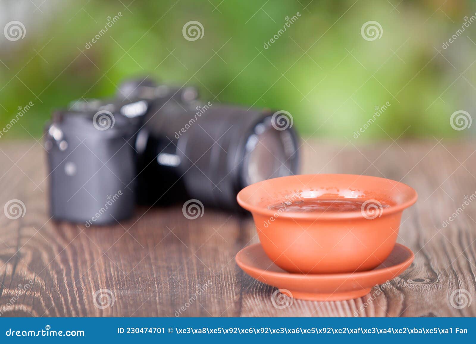 A bowl of tea and a camera stock image. Image of consumption - 230474701