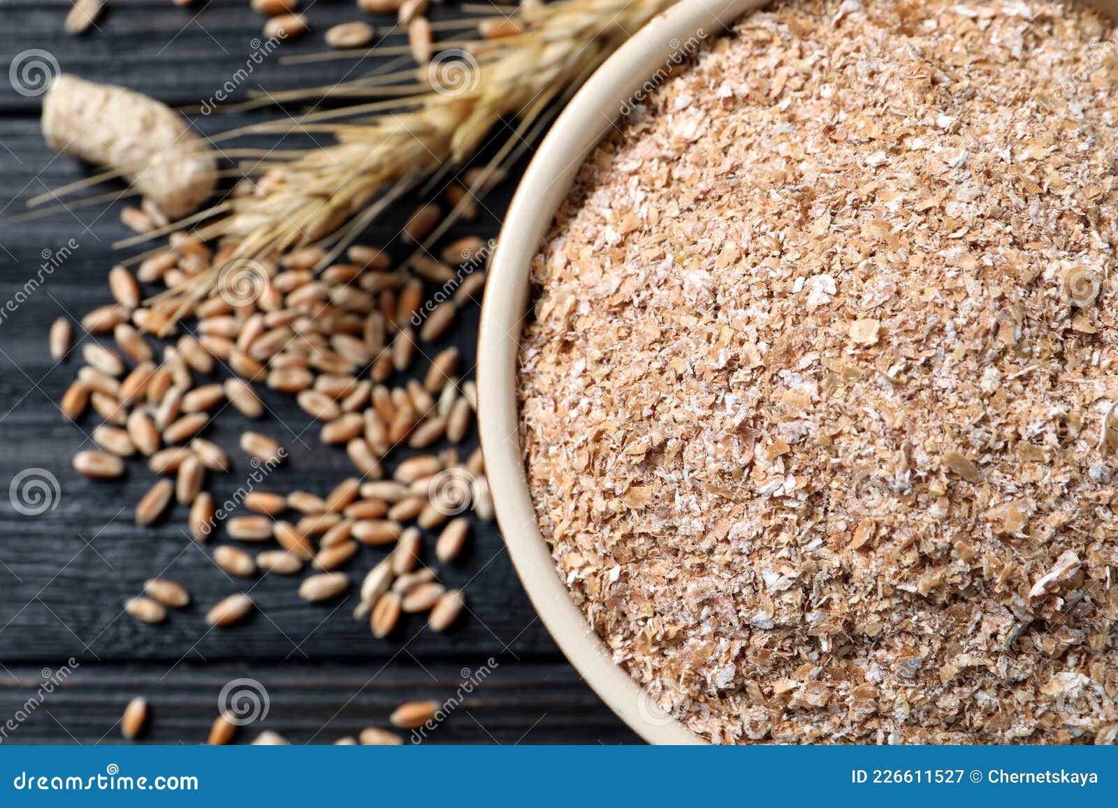 Bowl of Wheat Bran on Black Wooden Table, Flat Lay Stock Image - Image ...