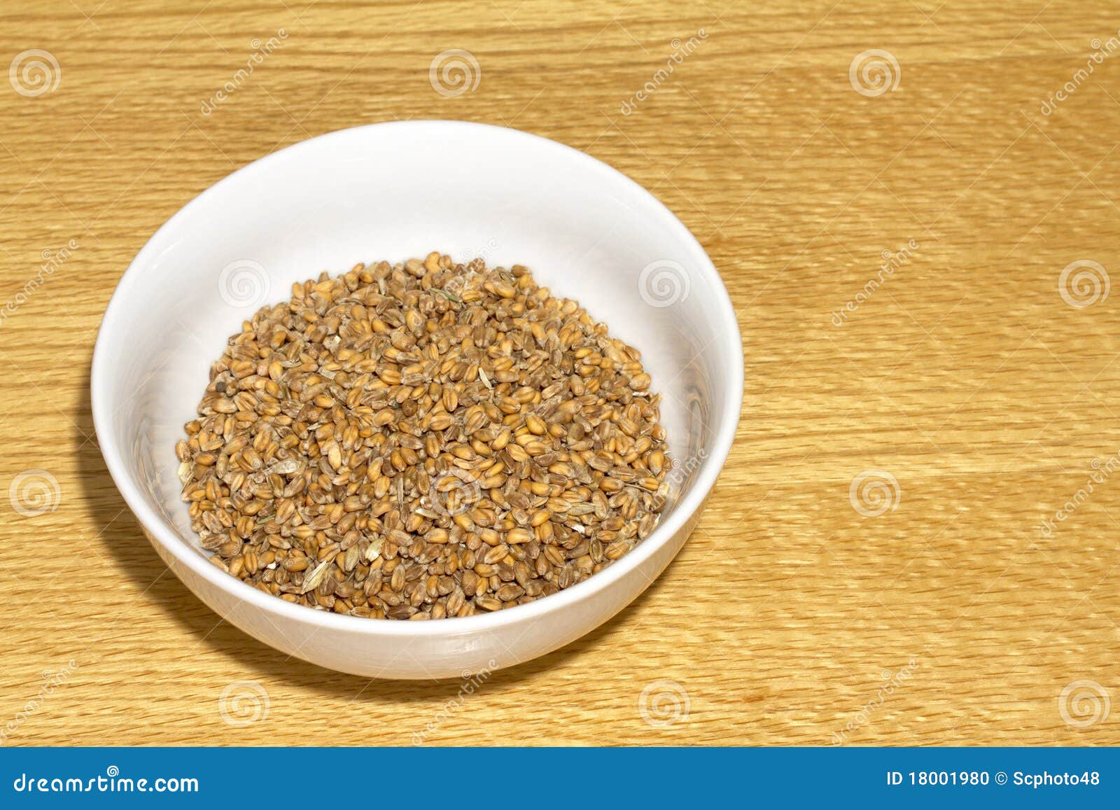 Bowl of wheat on table stock photo. Image of diet, plant - 18001980