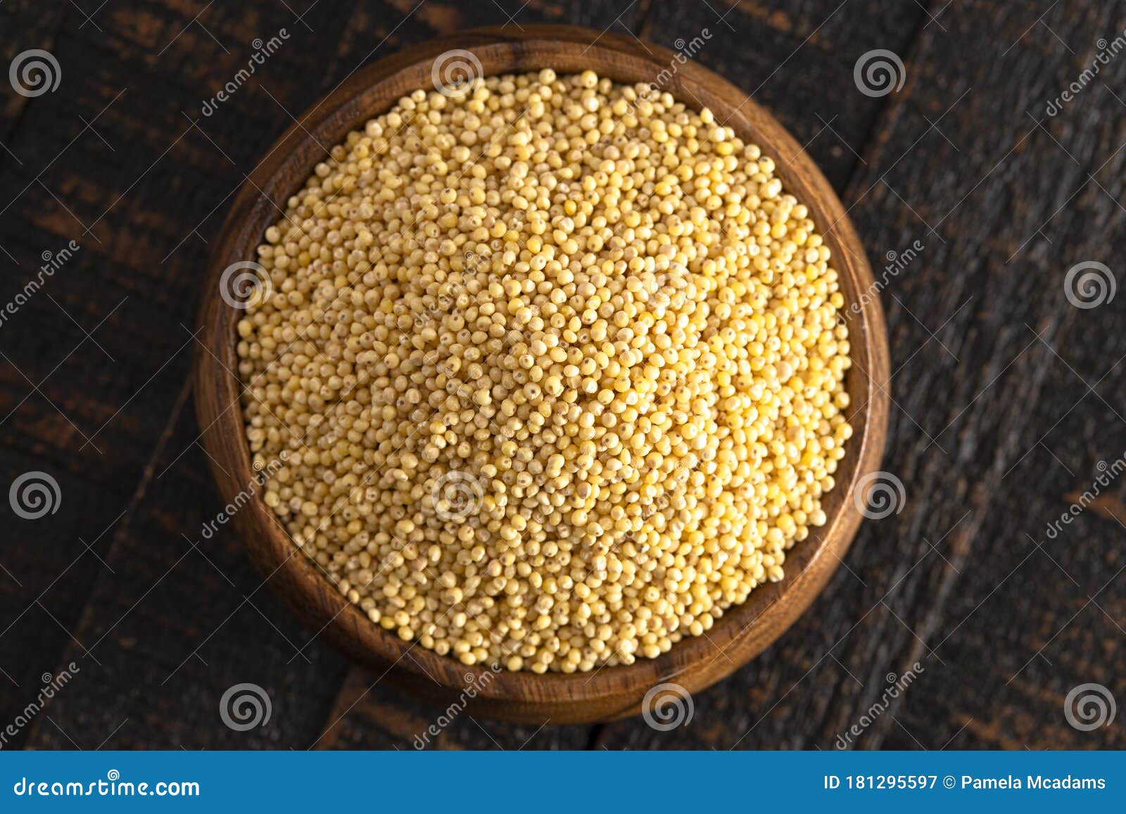 Bowl of Whole Millet in a Wood Bowl on a Rustic Dark Wood Table Stock ...