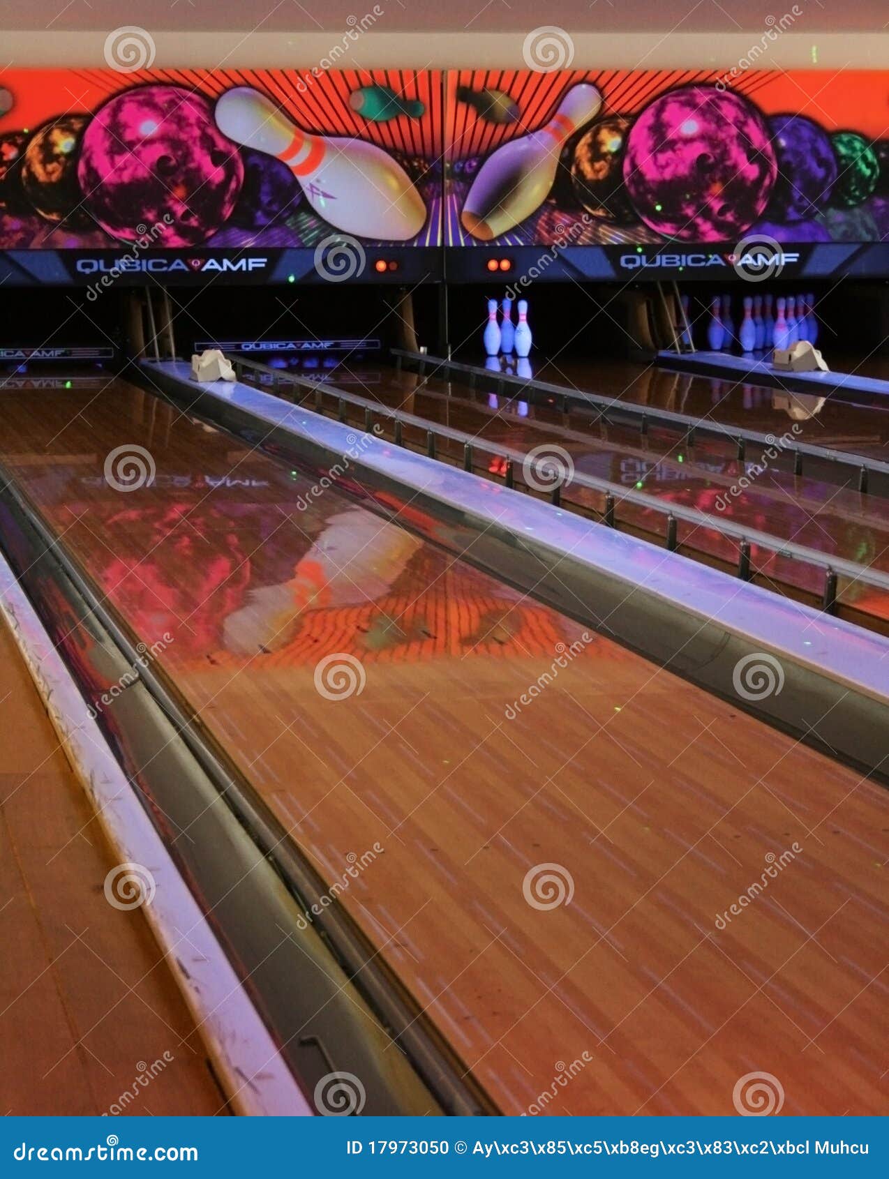 Blue Bowling Ball Rolling On The Track In The Bowling Center And ...