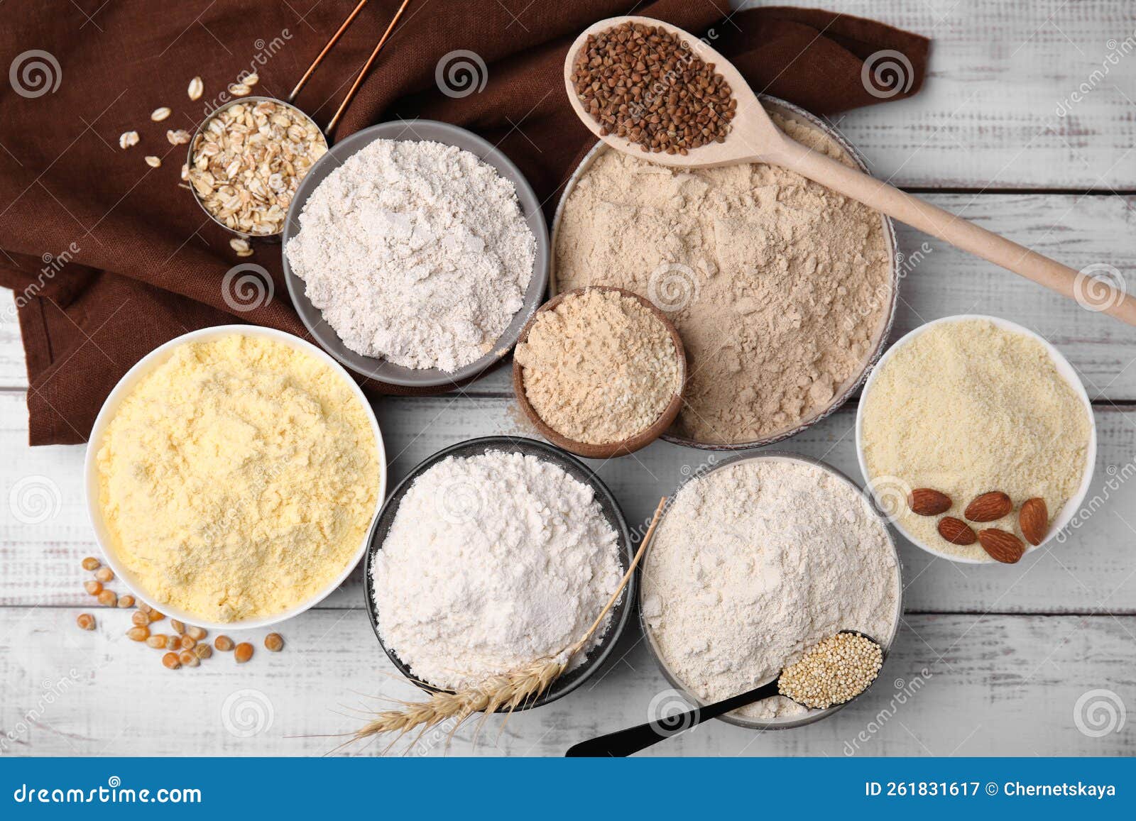 Bowls with Different Types of Flour and Ingredients on White Wooden ...