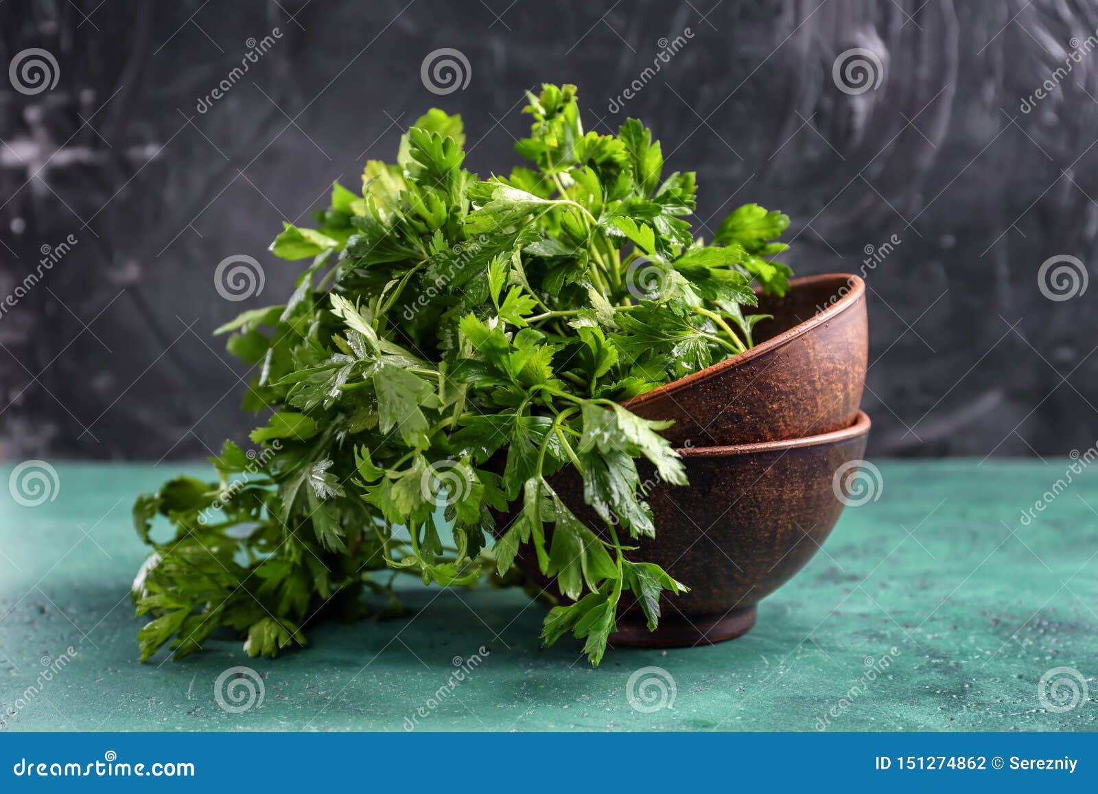 Bowls with Fresh Aromatic Parsley on Color Table Stock Photo - Image of ...